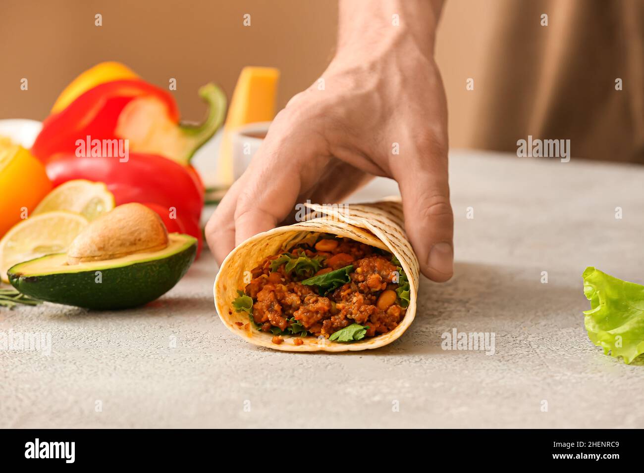 Hand holding mexican street food burrito hi-res stock photography and ...