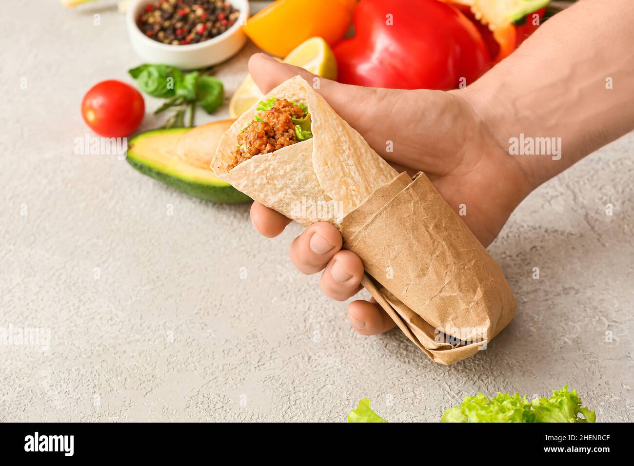 Hand holding mexican street food burrito hi-res stock photography and ...