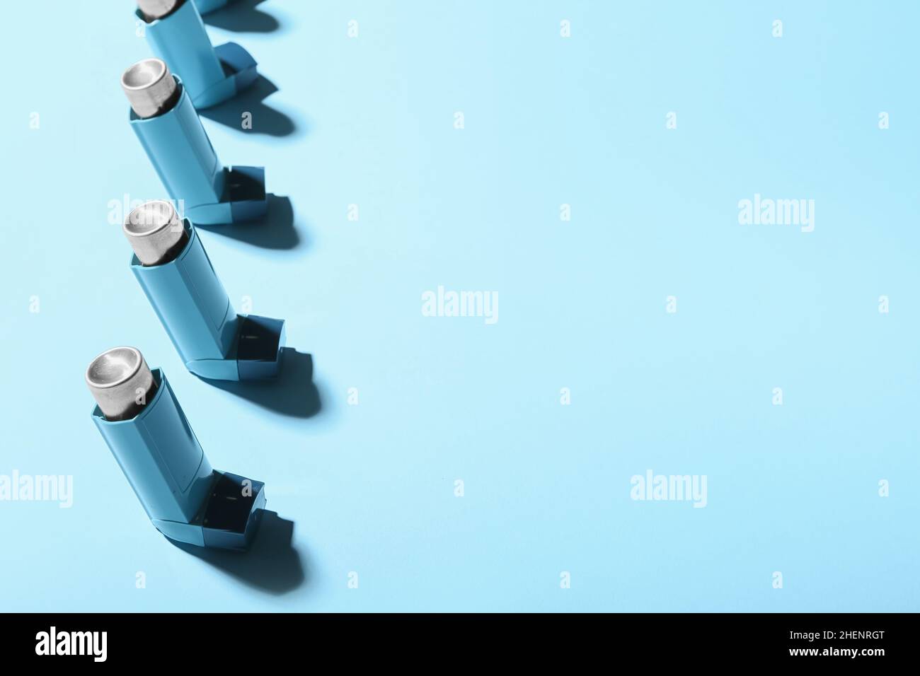 Asthma inhalers on blue background Stock Photo - Alamy