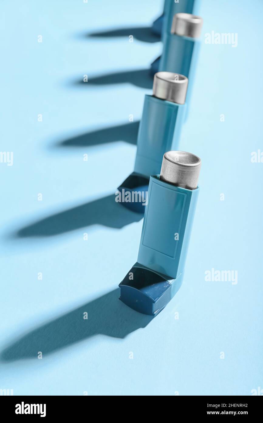 Asthma inhalers on blue background, closeup Stock Photo - Alamy