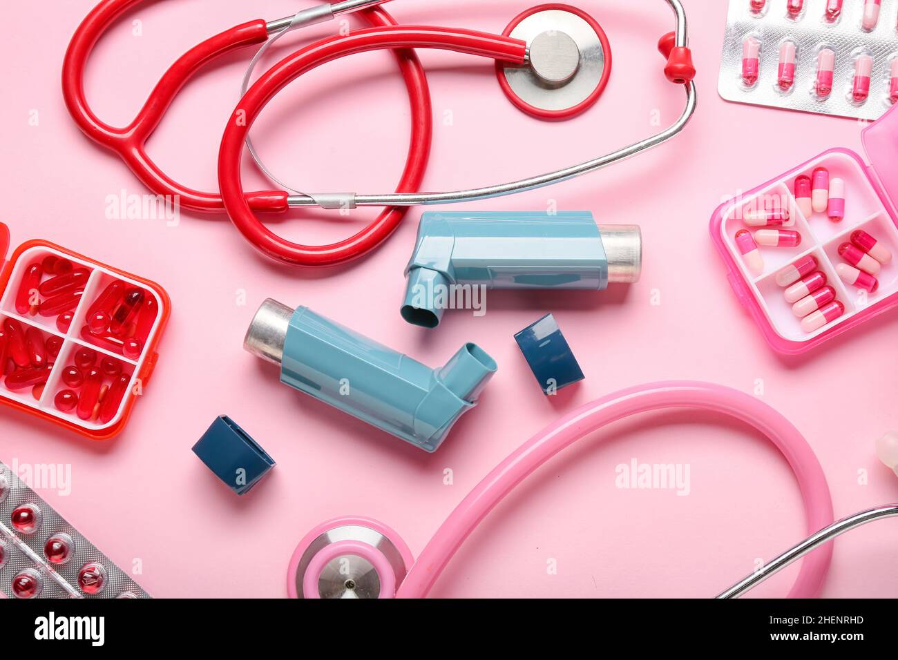 Asthma inhalers, stethoscopes and pills on pink background Stock Photo ...