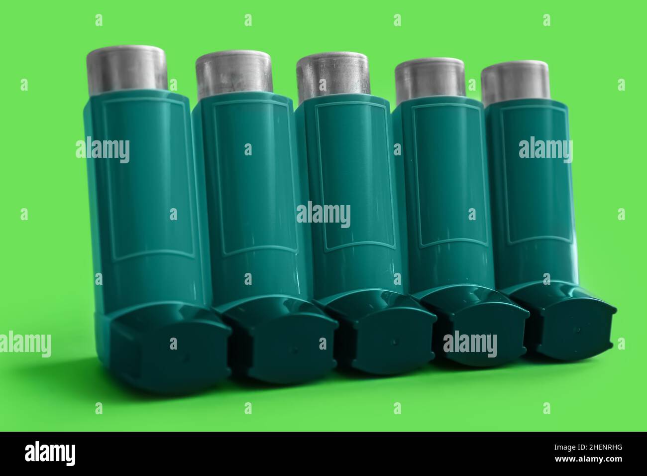 Asthma inhalers on green background, closeup Stock Photo - Alamy