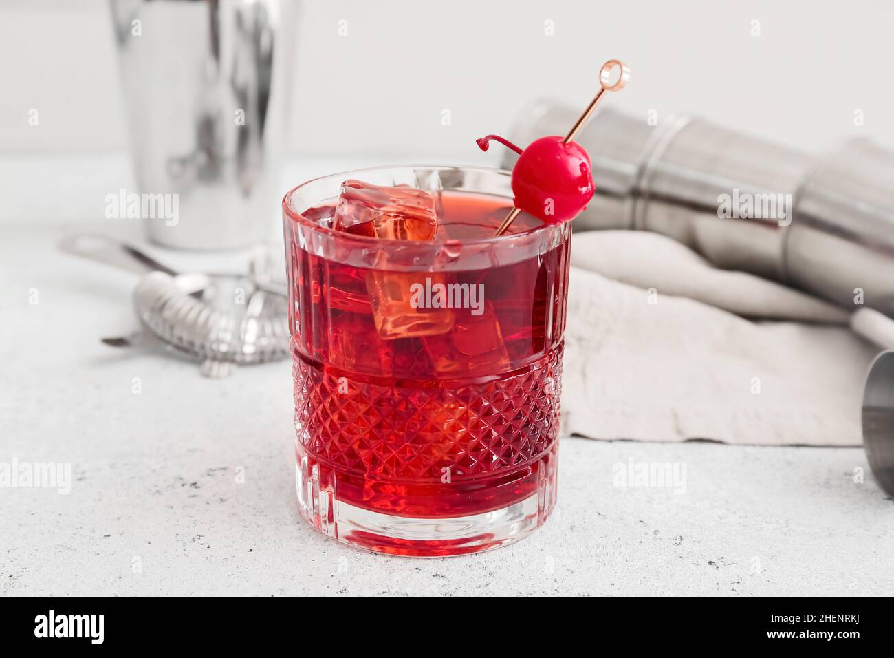 Glass of iced Manhattan cocktail on light background, closeup Stock ...