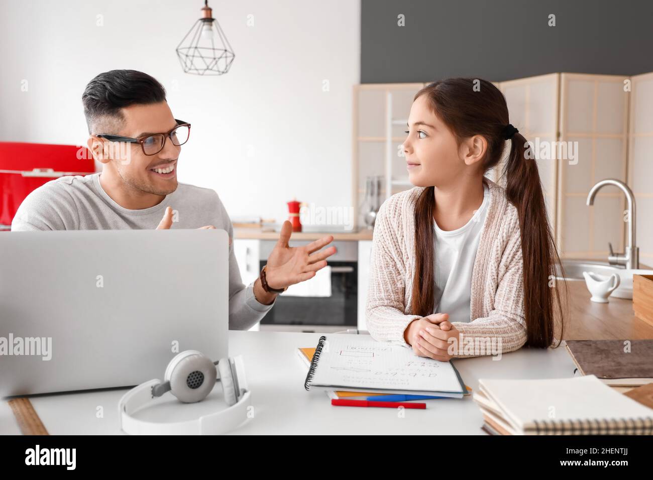Little girl studying with tutor at home Stock Photo - Alamy