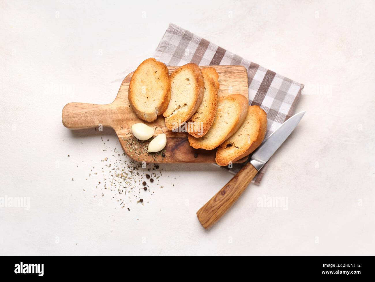 Wooden board with tasty croutons on white background Stock Photo - Alamy