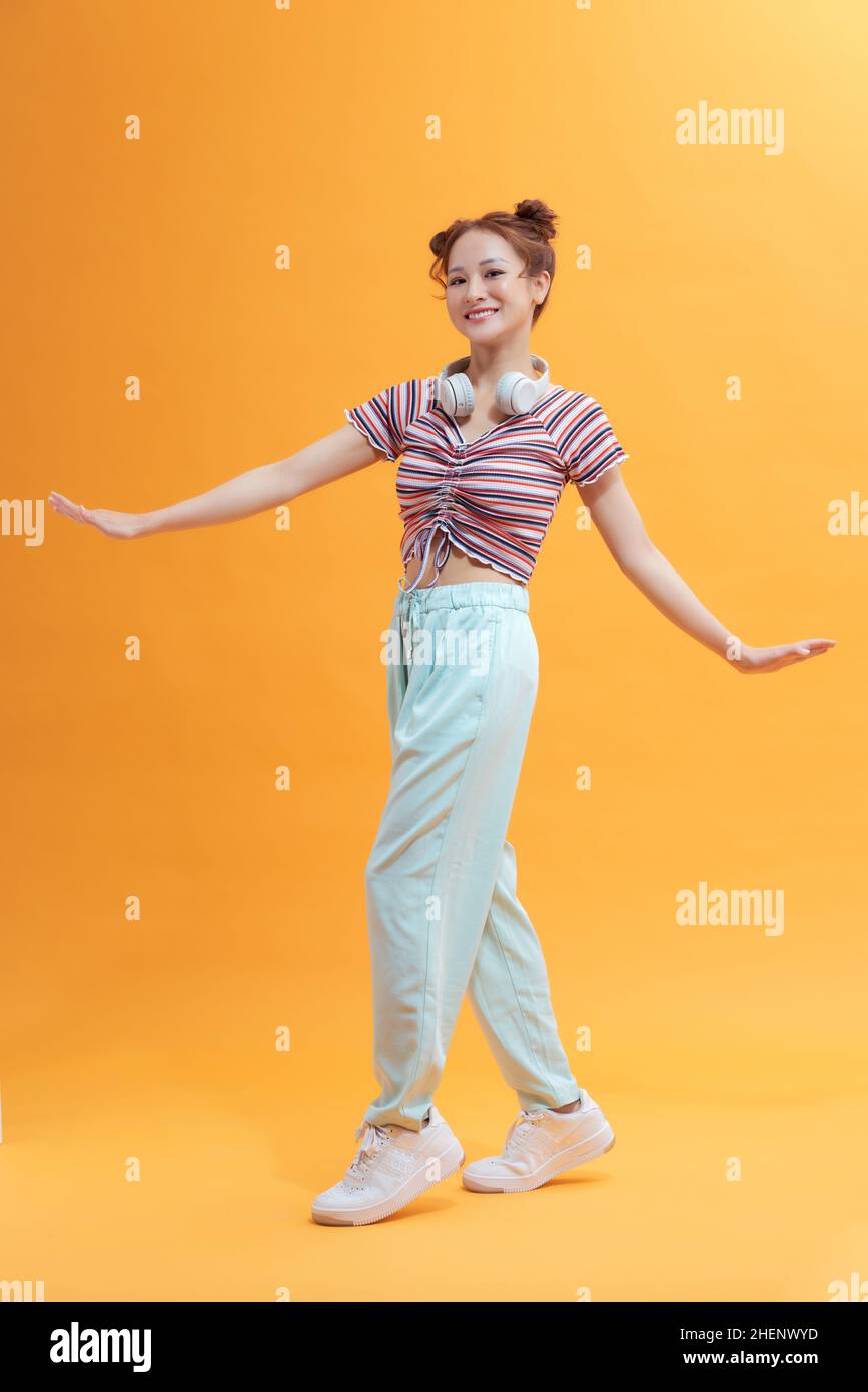 Having Fun. Full body length portrait of happy young asian woman ...