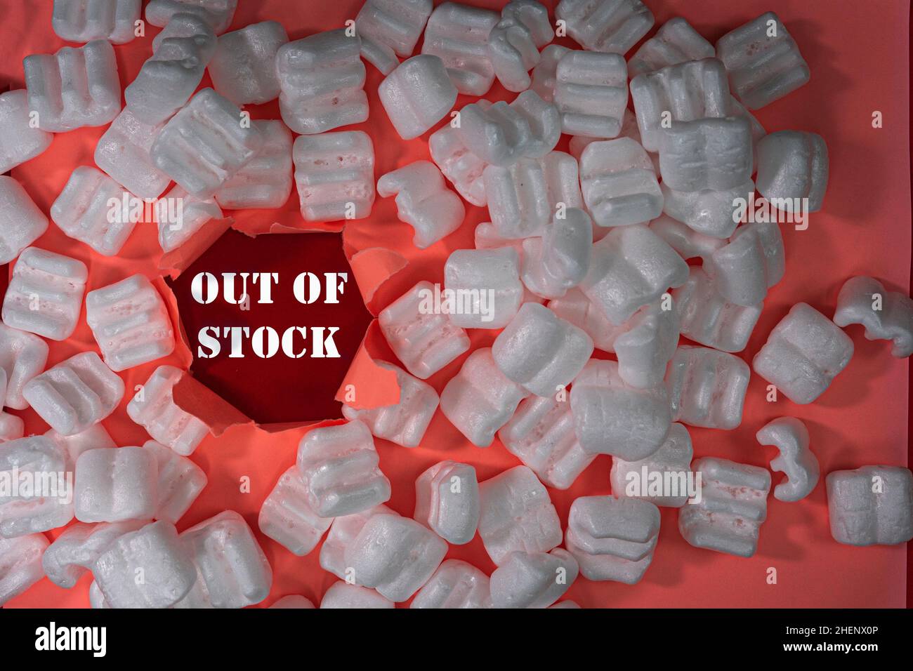 Business concept. Layout of packing peanuts, torn paper with text OUT ...