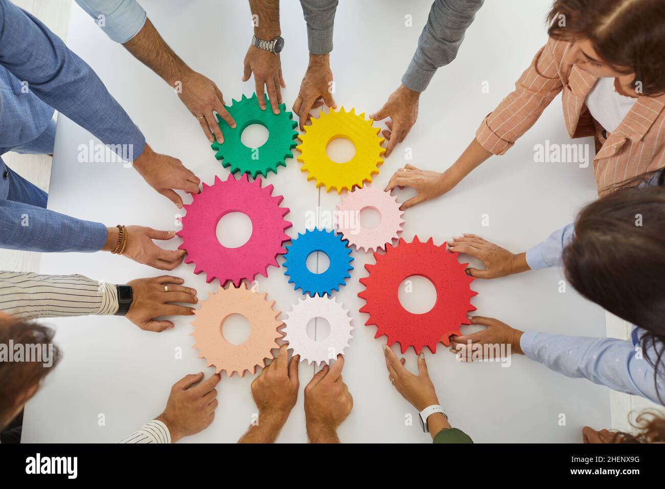 Business team connecting gear wheels to illustrate concept of teamwork ...