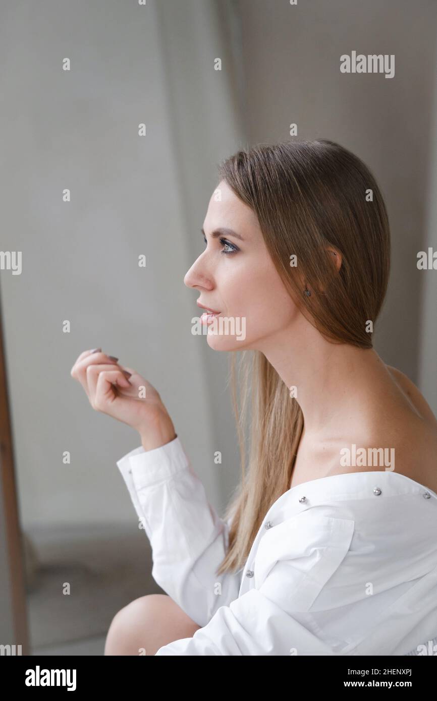 Pretty gentle Caucasian woman happy in white shirt. Daring fashion ...