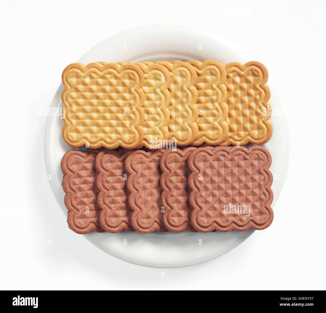 Chocolate and vanilla square cookies in plate on white background, top ...