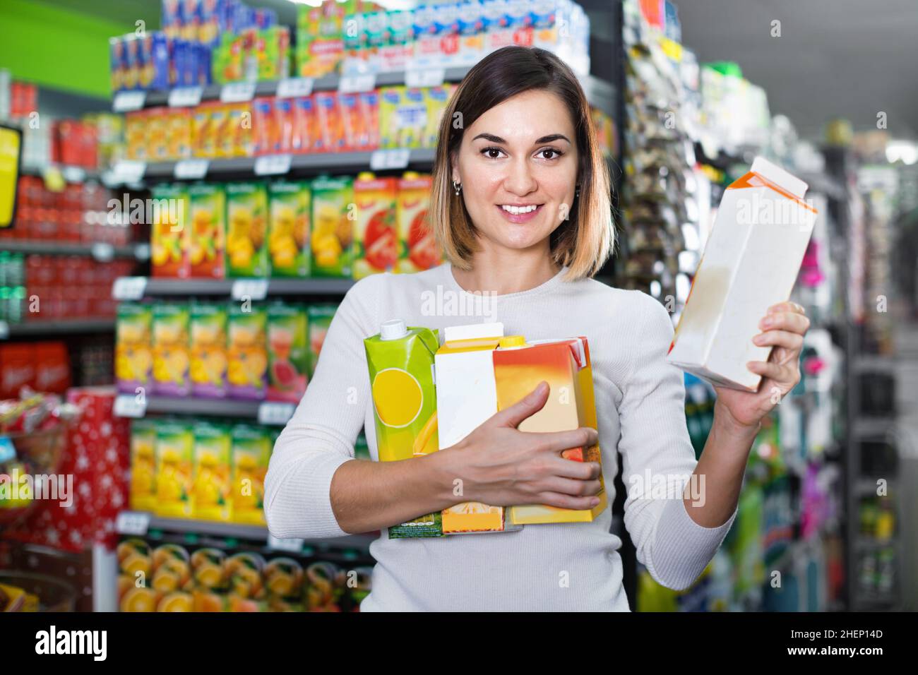Woman choosing refreshing beverages in supermarket Stock Photo - Alamy