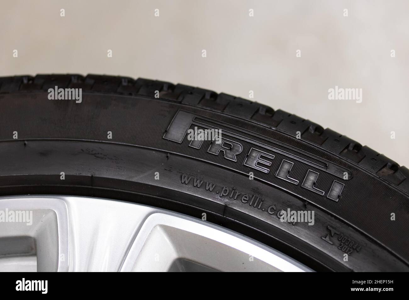 The Pirelli logo is on the tire of a new tire in a garage. Pirelli, an ...