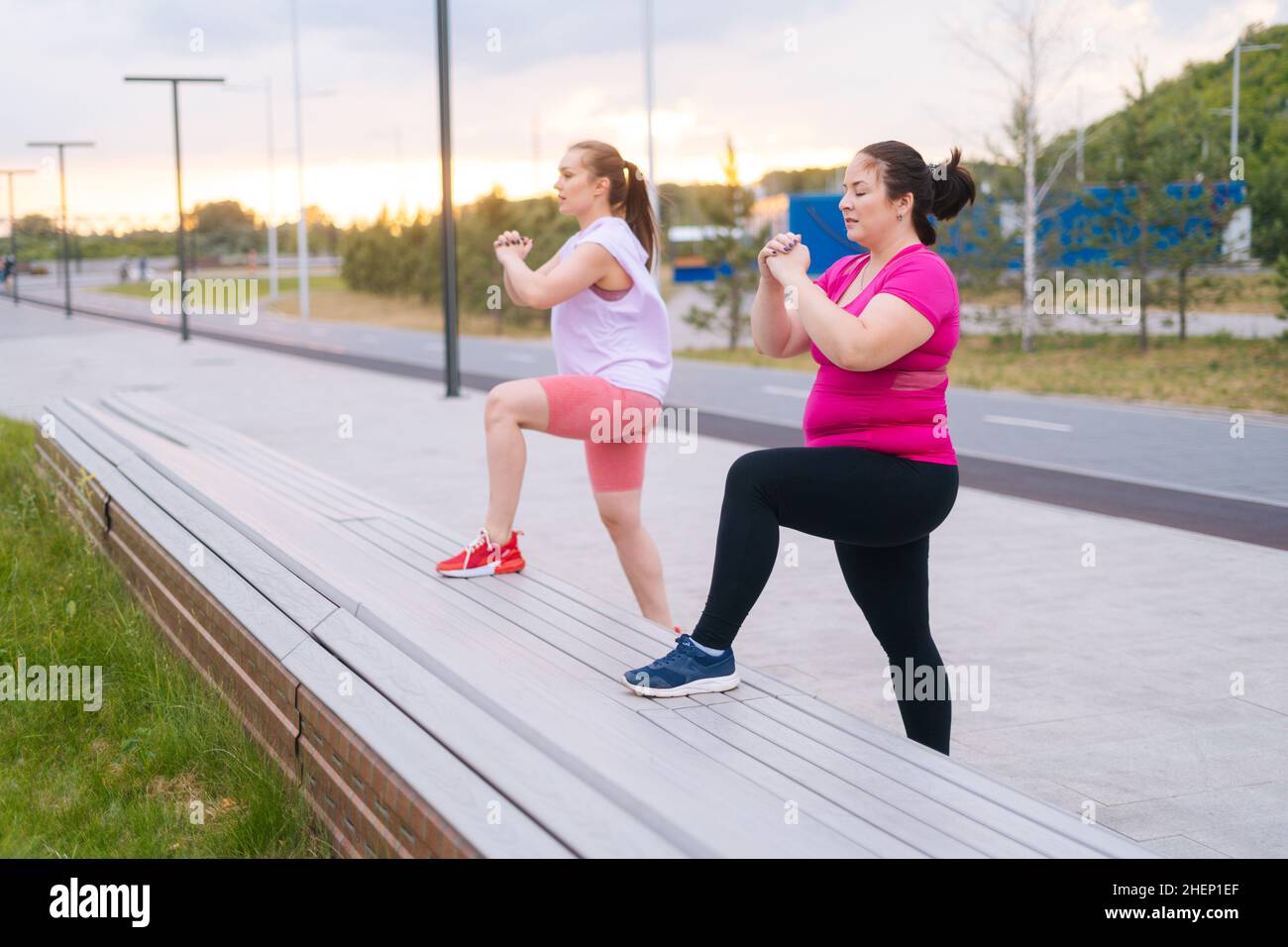 Obese overweight young woman doing single leg squats using bench with ...