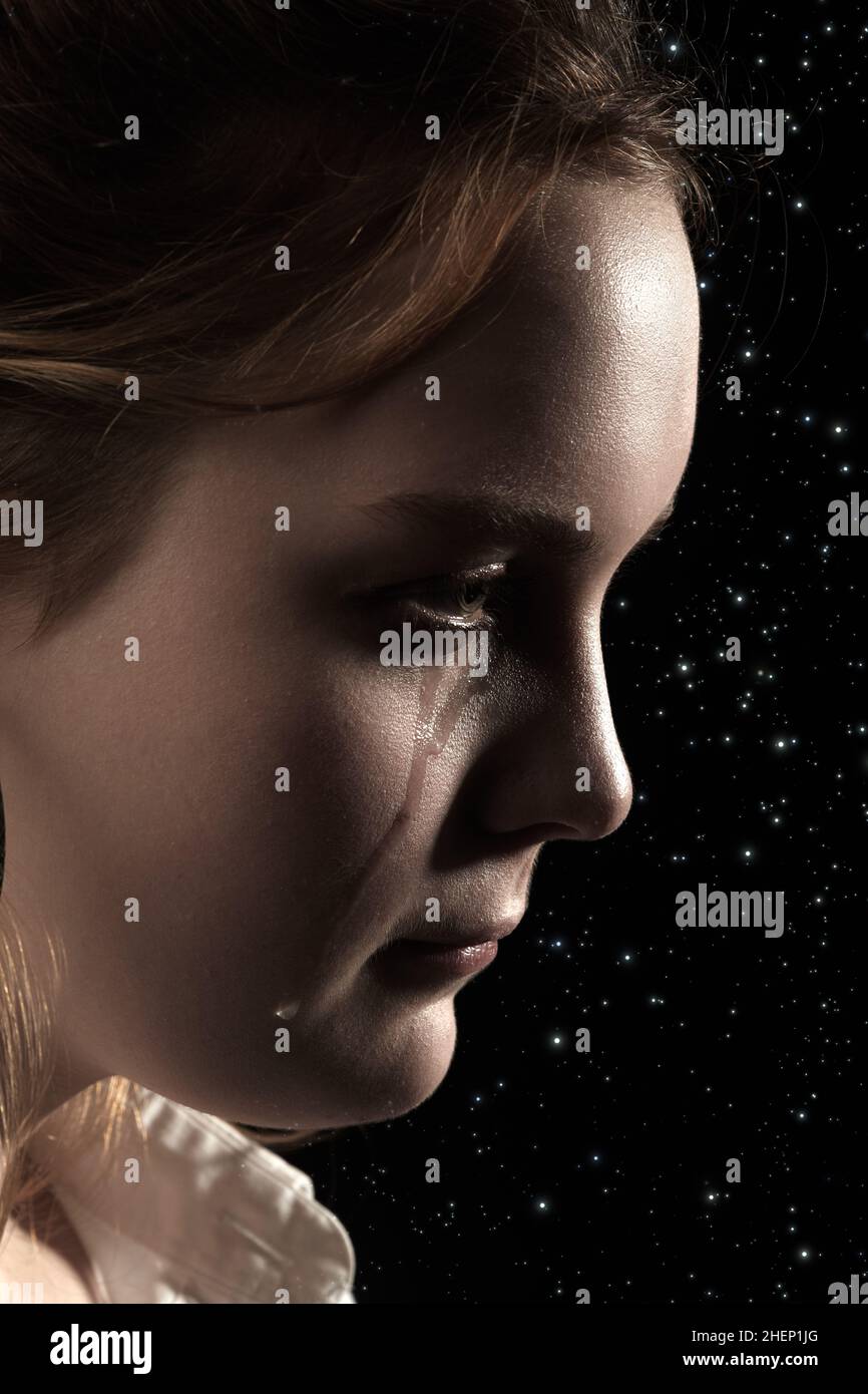 sad woman crying, looking aside on stars background, closeup portrait ...