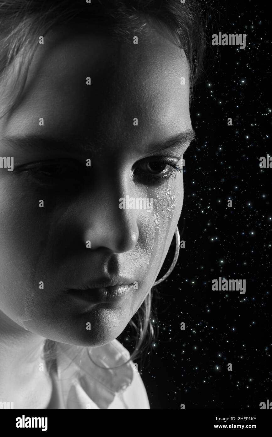 sad woman crying, looking aside on stars background, closeup portrait ...