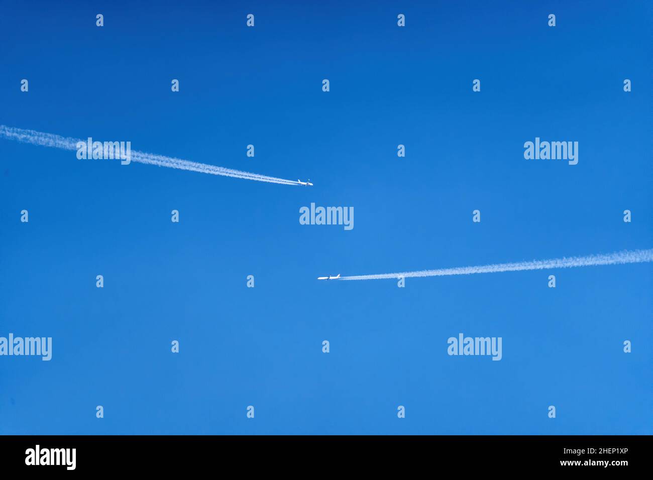 Two airplanes in the sky closely passing by each other Stock Photo - Alamy