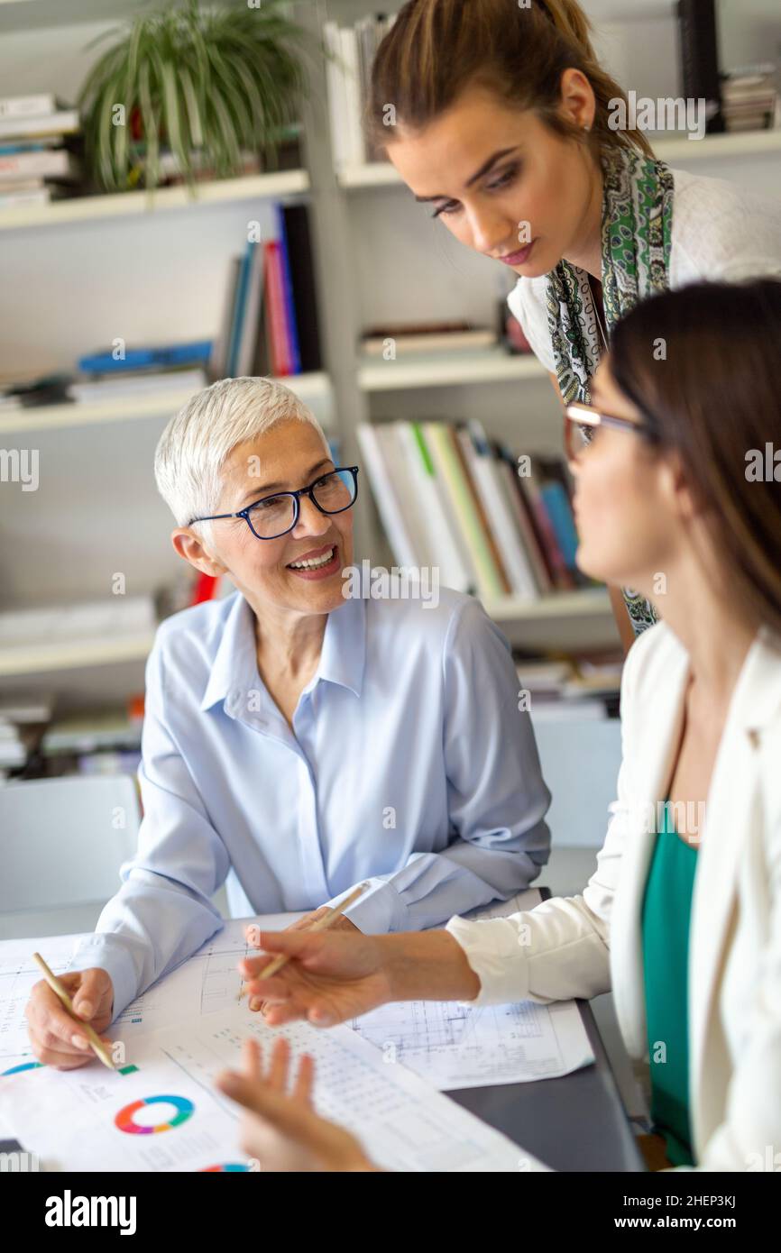 Portrait of happy business women working as a team at the office on ...