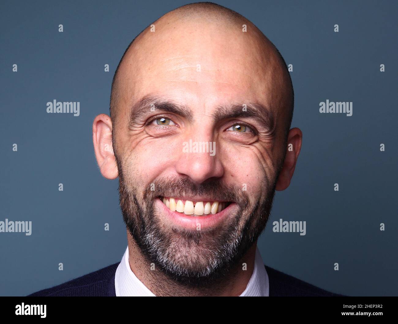 Portrait of a beautiful happy man in front of a colored background ...