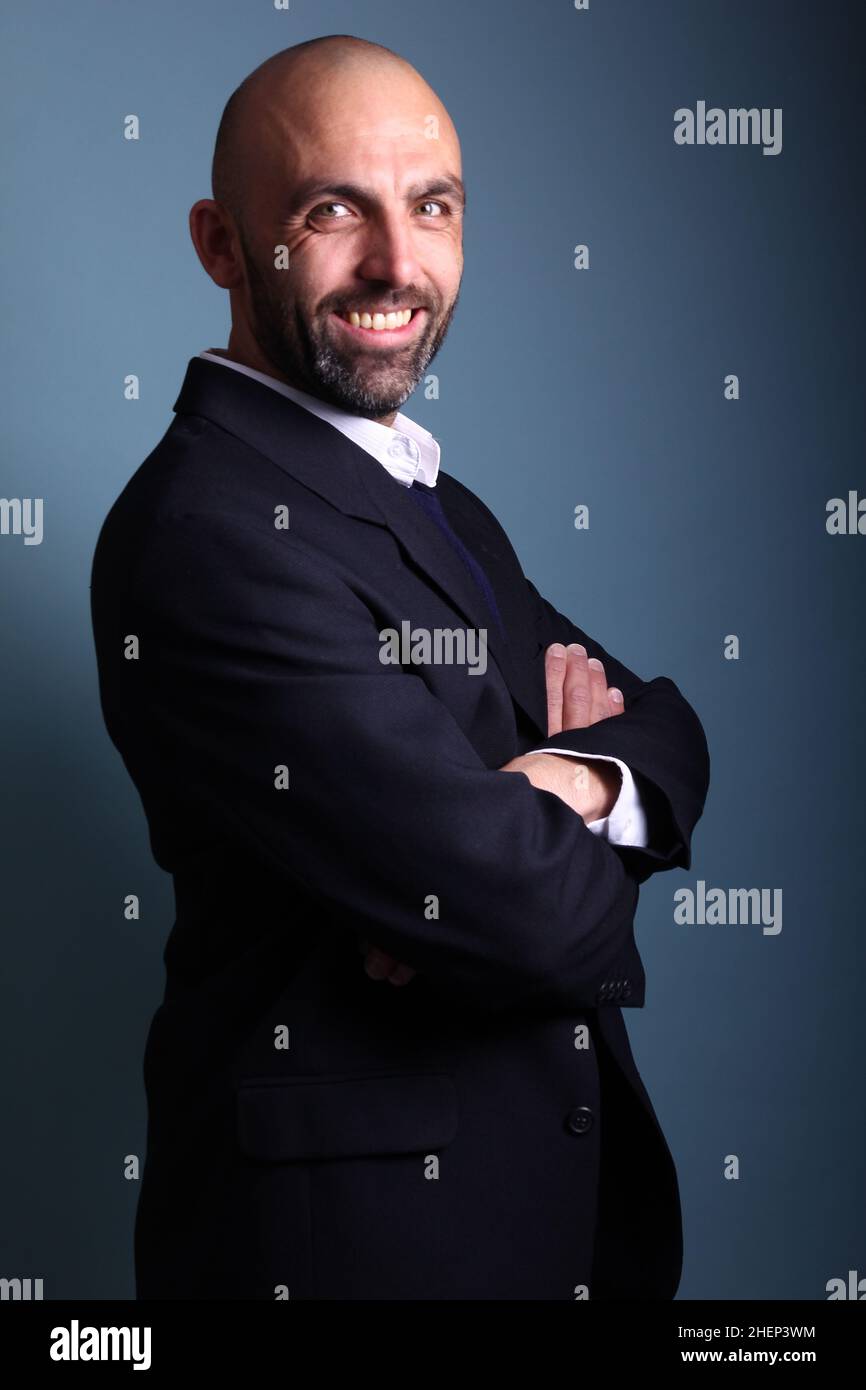 Portrait of a beautiful happy man in front of a colored background ...