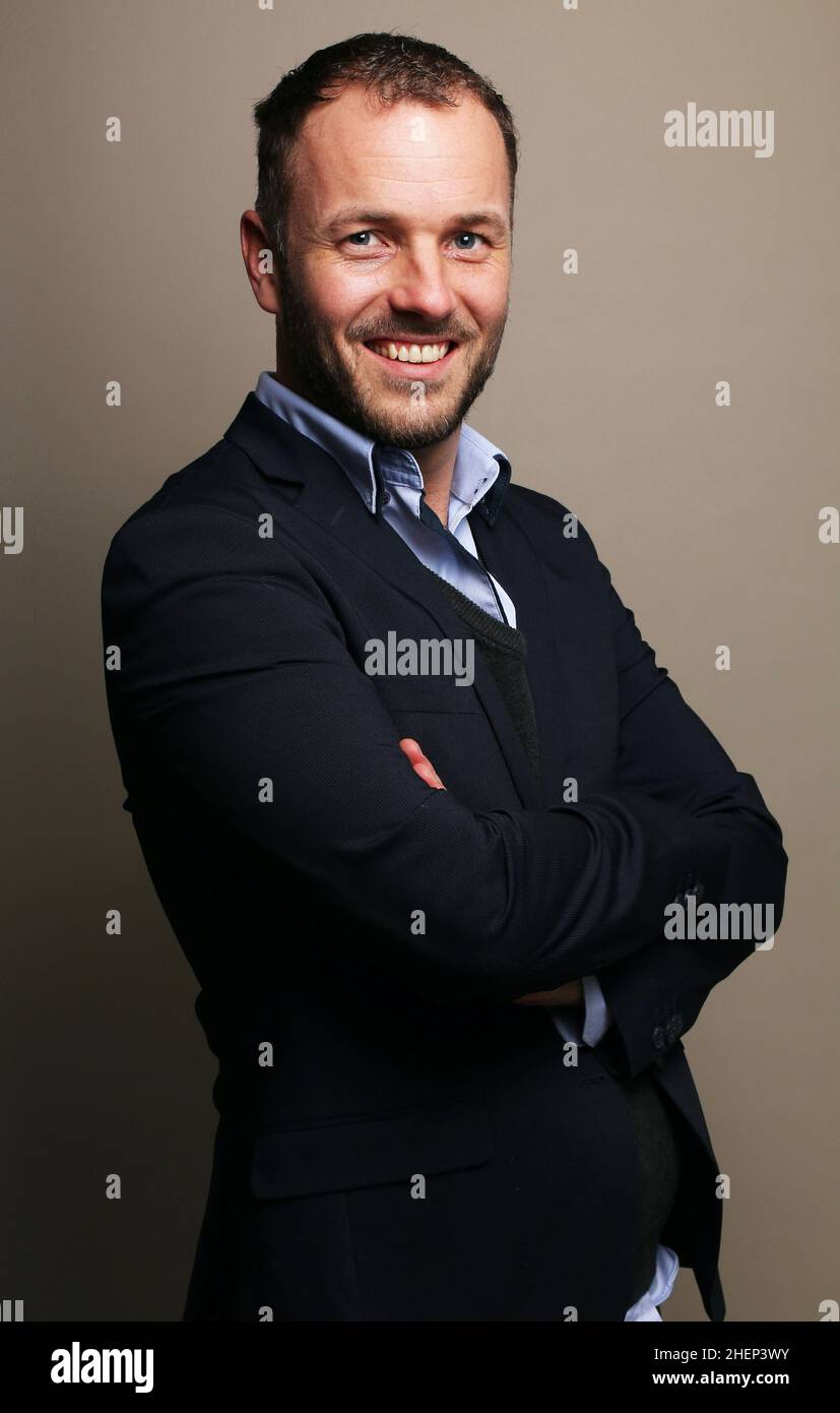 Portrait of a beautiful happy man in front of a colored background ...