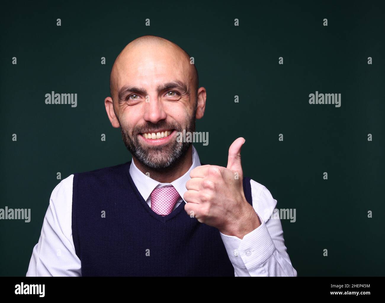 Portrait of a beautiful happy man in front of a colored background ...