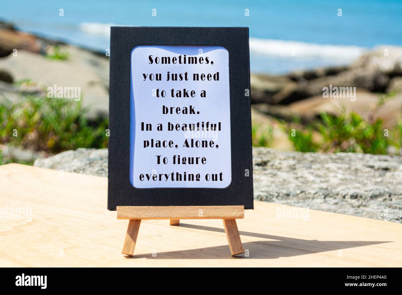 Motivational and Inspirational quote on a notepad with blurred beach ...