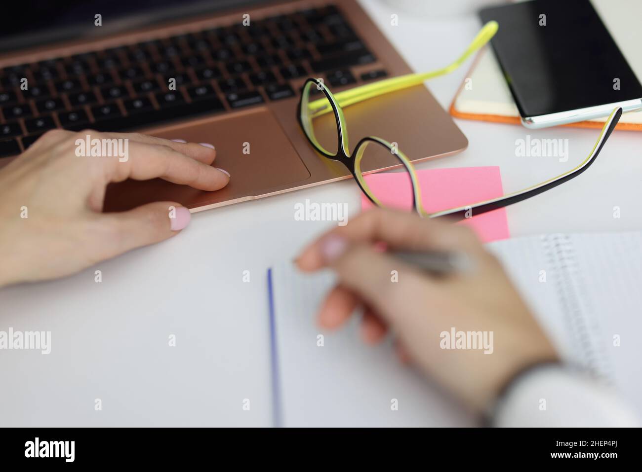 Male hold pen and make notes in notebook, plan day, working at laptop ...