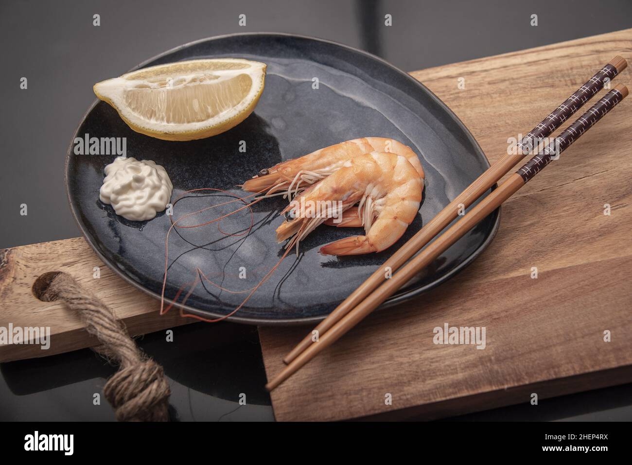 Roasted tails of shrimps with fresh rosemary and lemon Stock Photo - Alamy