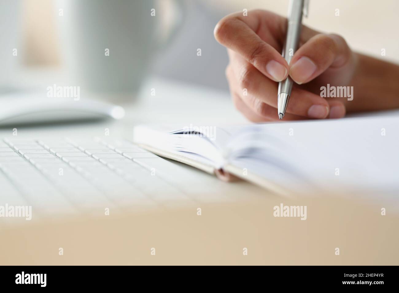 Persons hand writing down ideas in diary, notes for future, planning ...