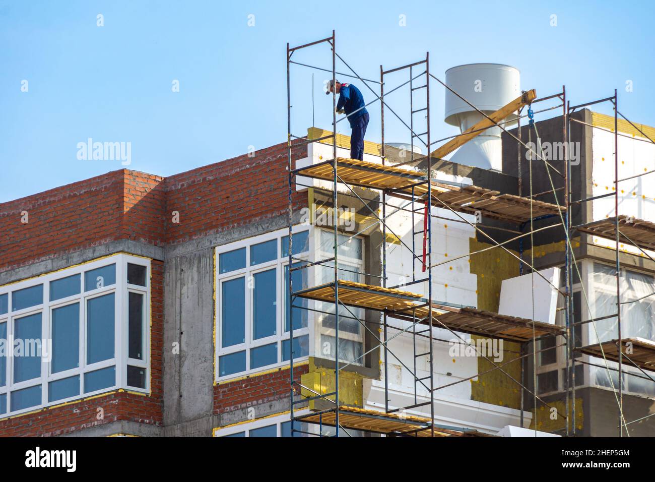 finishing with mineral and polystyrene insulation of the facade of a ...
