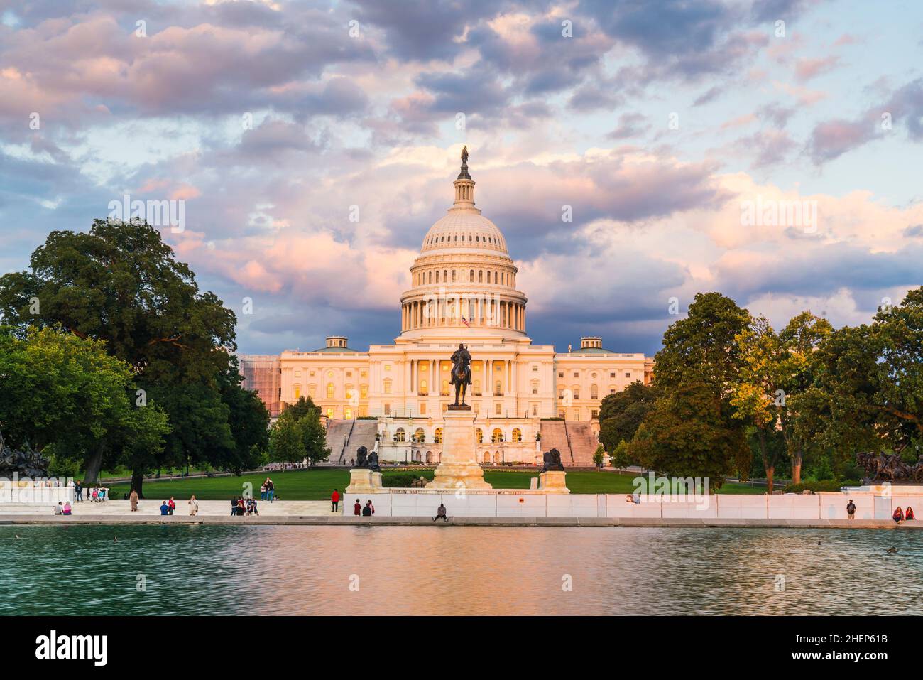 The United States Capitol building at sunset wirh reflection in water ...