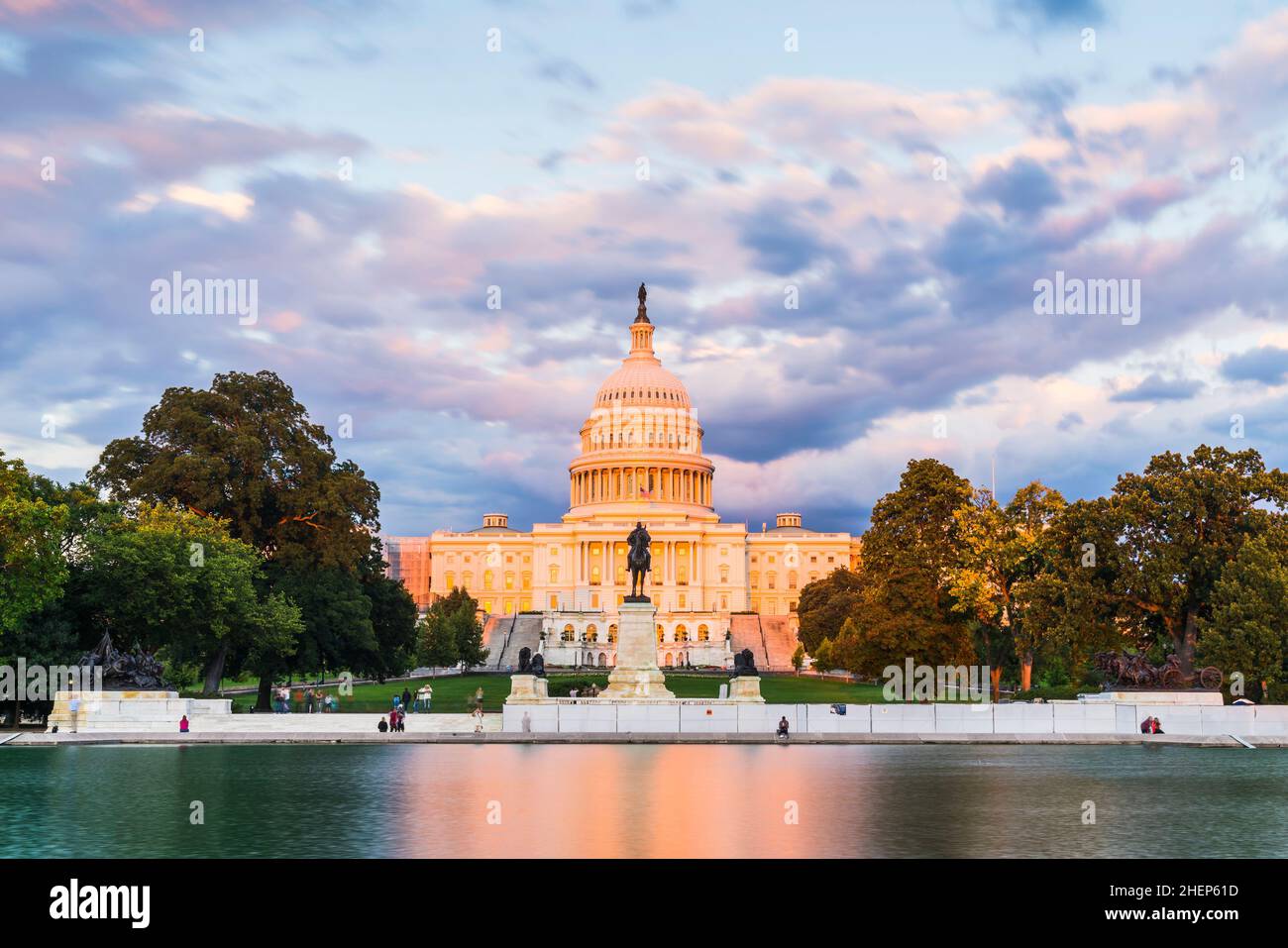 The United States Capitol building at sunset wirh reflection in water ...
