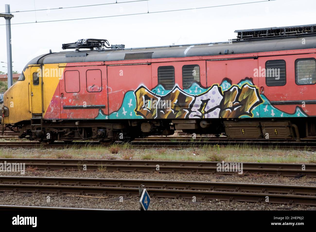 A retired electric locomotive retired to a siding, now adorned with ...