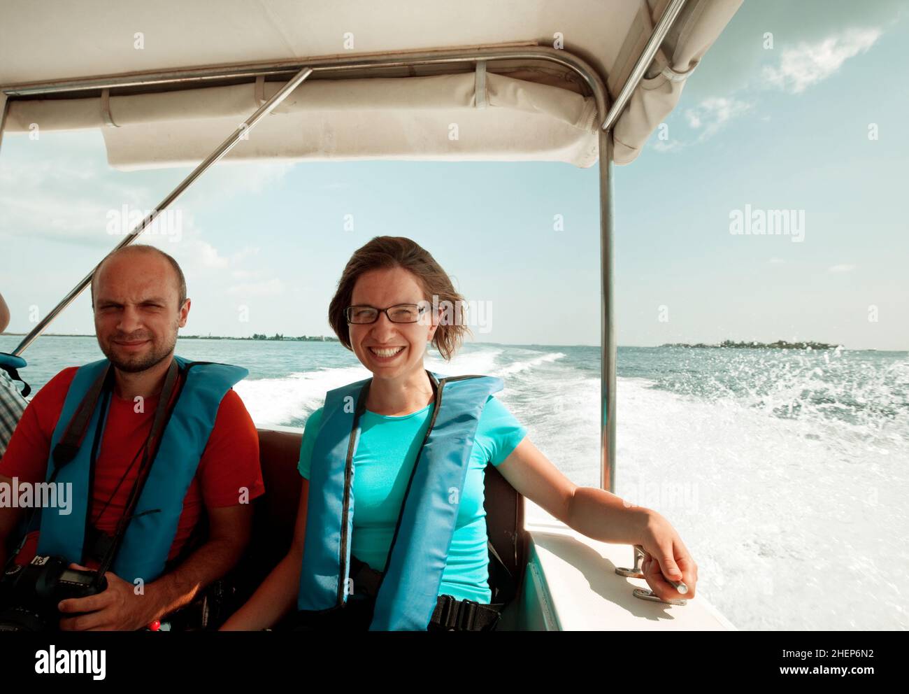 A couple of happy tourists on a speedboat Stock Photo - Alamy