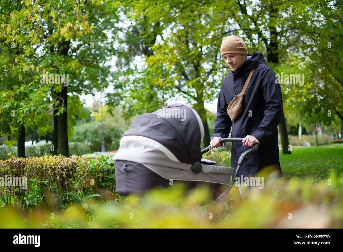 Happy young father with pram during the walk in nature Stock Photo - Alamy