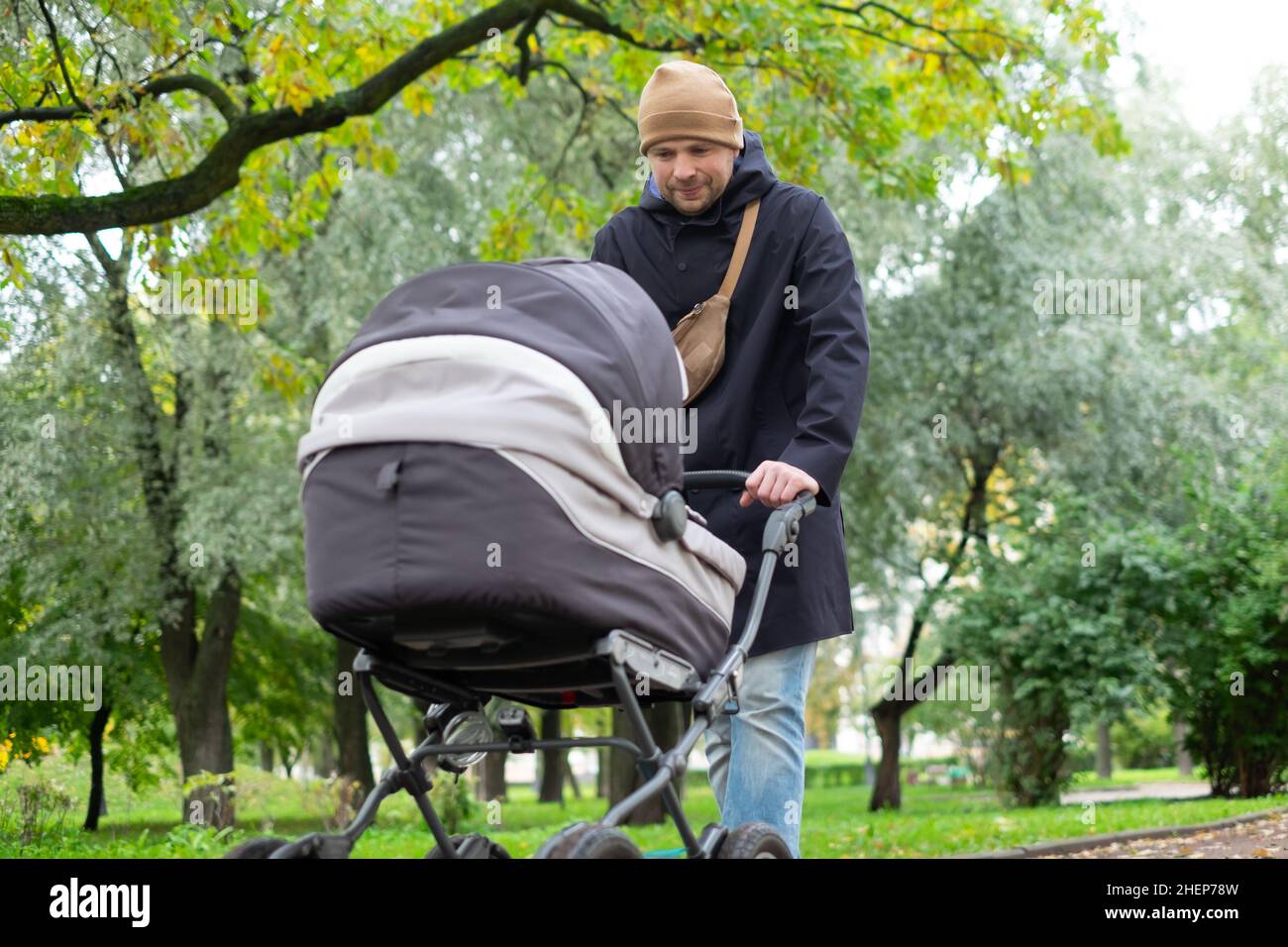 Happy young father with pram during the walk in nature Stock Photo - Alamy