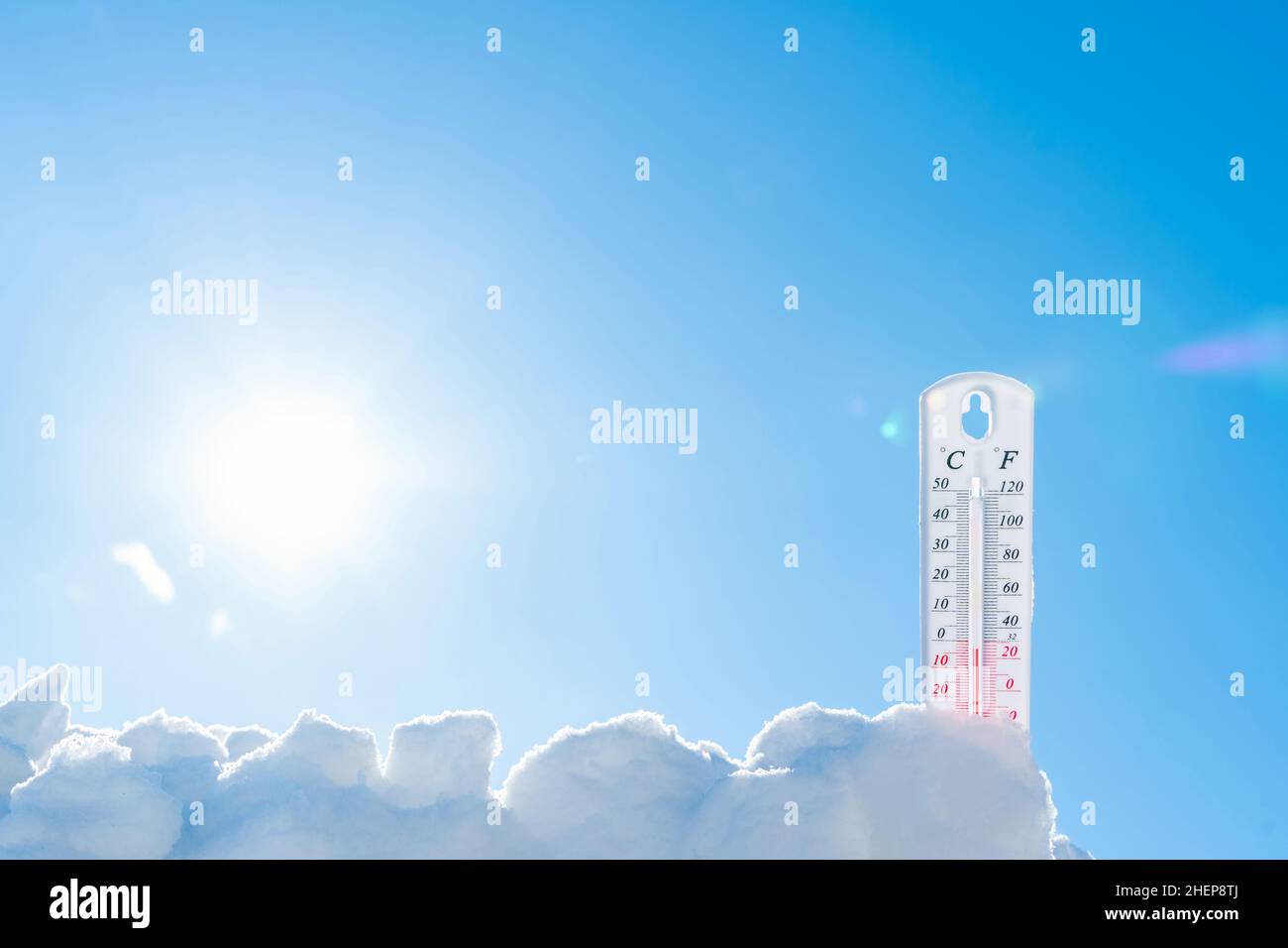 The thermometer lies on the snow in winter showing a negative ...