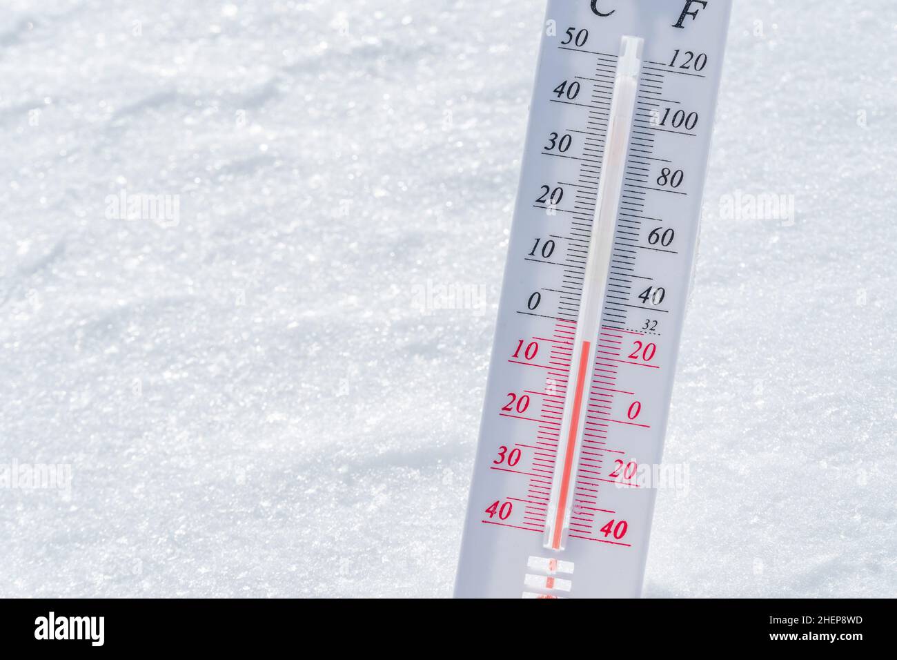 The thermometer lies on the snow in winter showing a negative ...