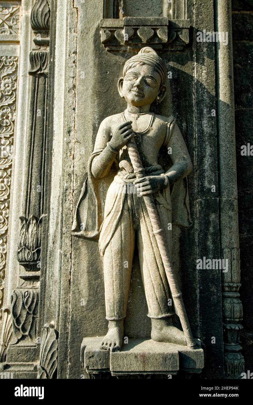 A guard watchman carved in stone on the gate of Maheshwar Temple Stock ...