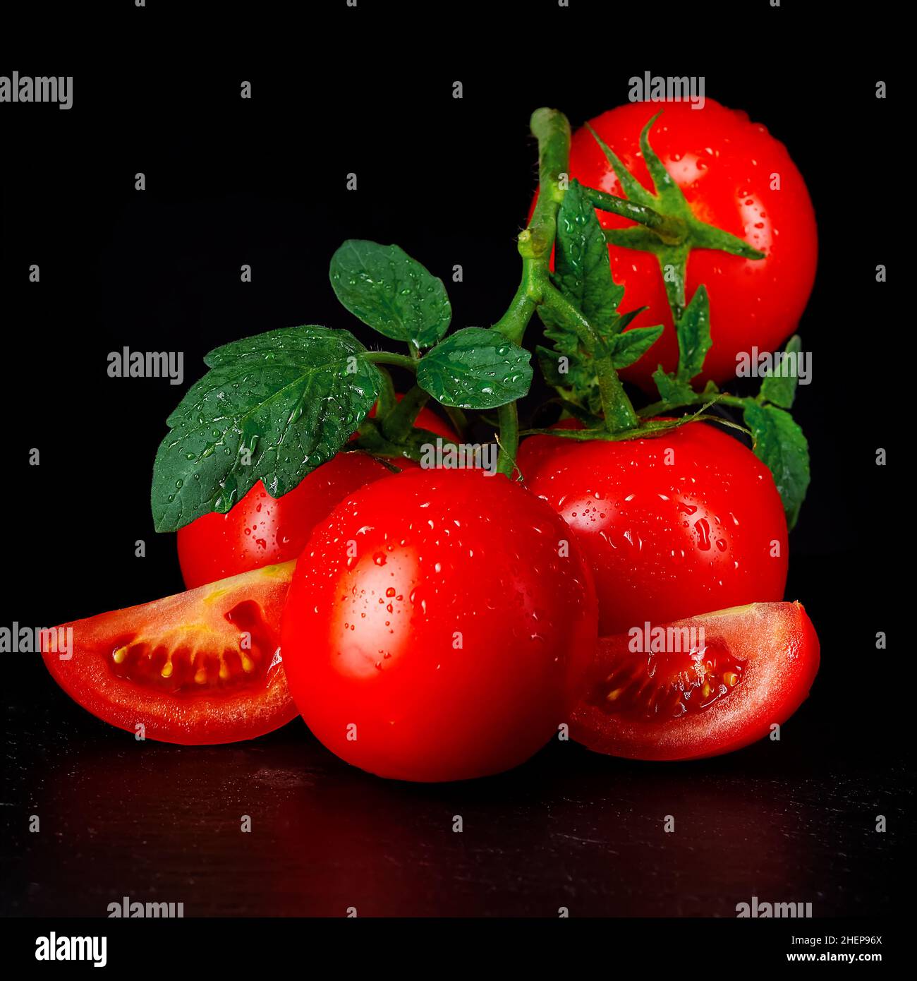 Ripe organic tomatoes on the black table in low key with water drops Stock Photo - Alamy