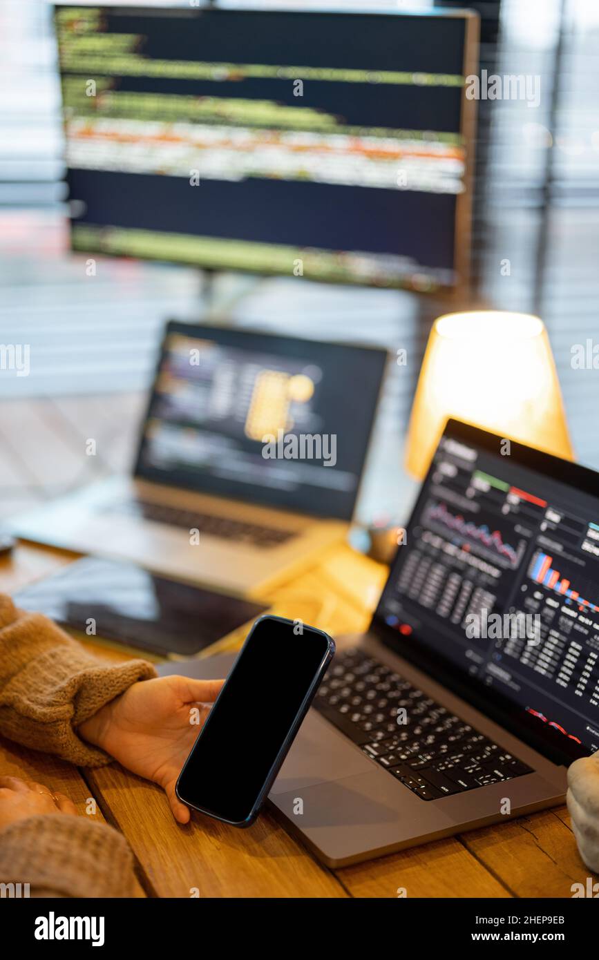 Cozy workplace with laptop and desktop computers with programming code ...