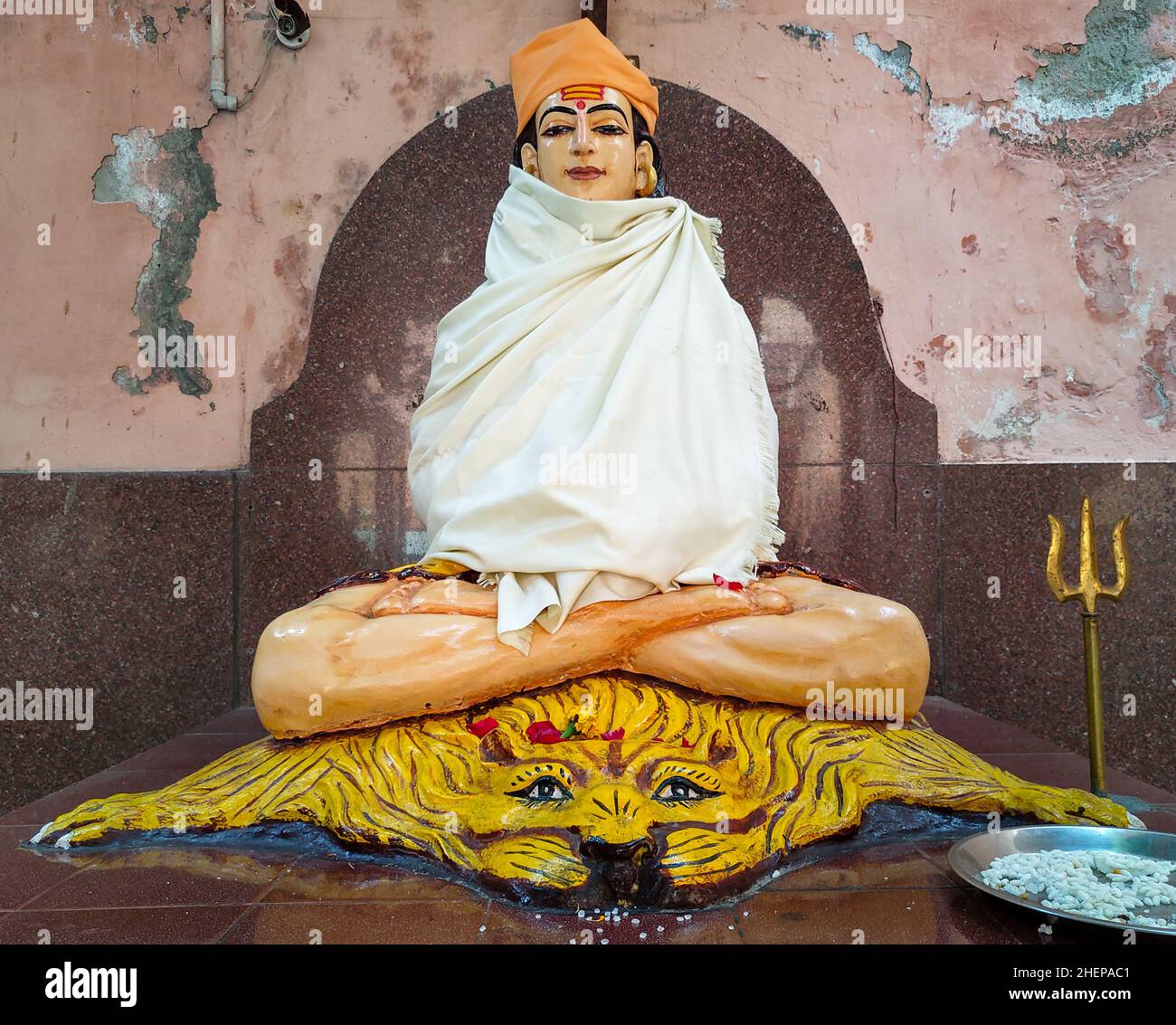A close up shot of a hindu saint statue in meditative form who had ...