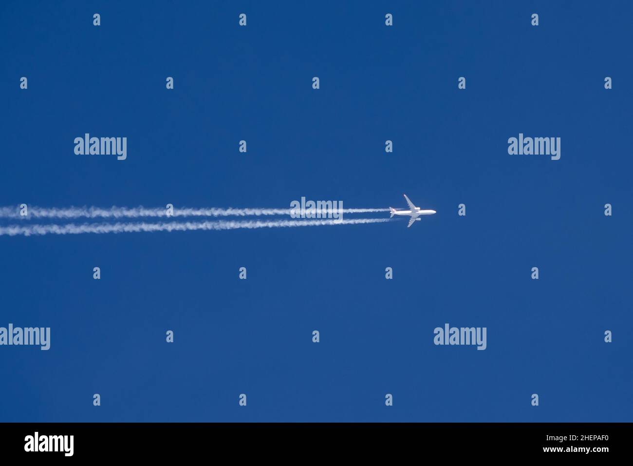 Airplane in the sky aviation airport contrail clouds Stock Photo - Alamy