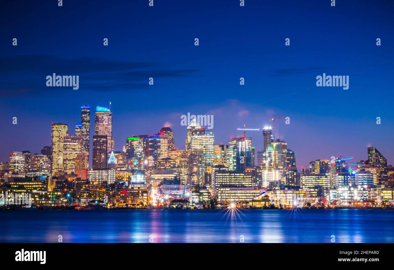 seattle city skyline at night with reflection in water. seattle ...