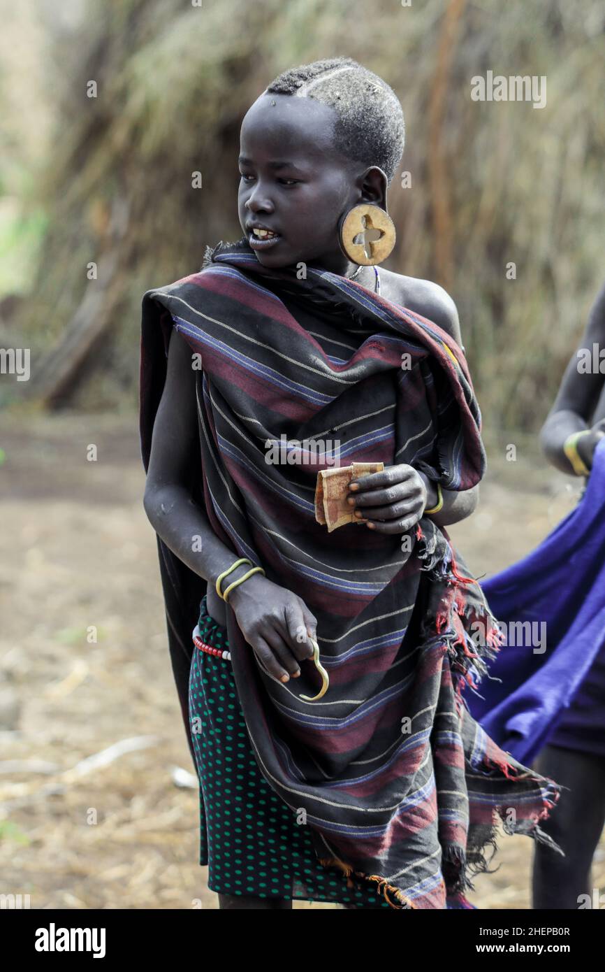 Mursi People Children in National Costumes in the Tribe Village Stock ...