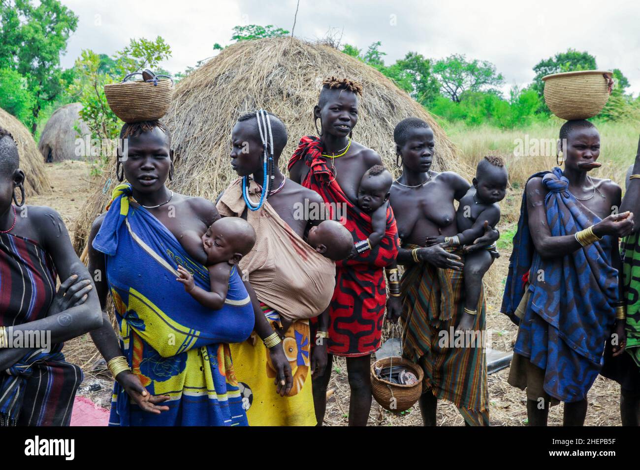 Mursi People Women in National Costumes in the Tribe Village Stock ...