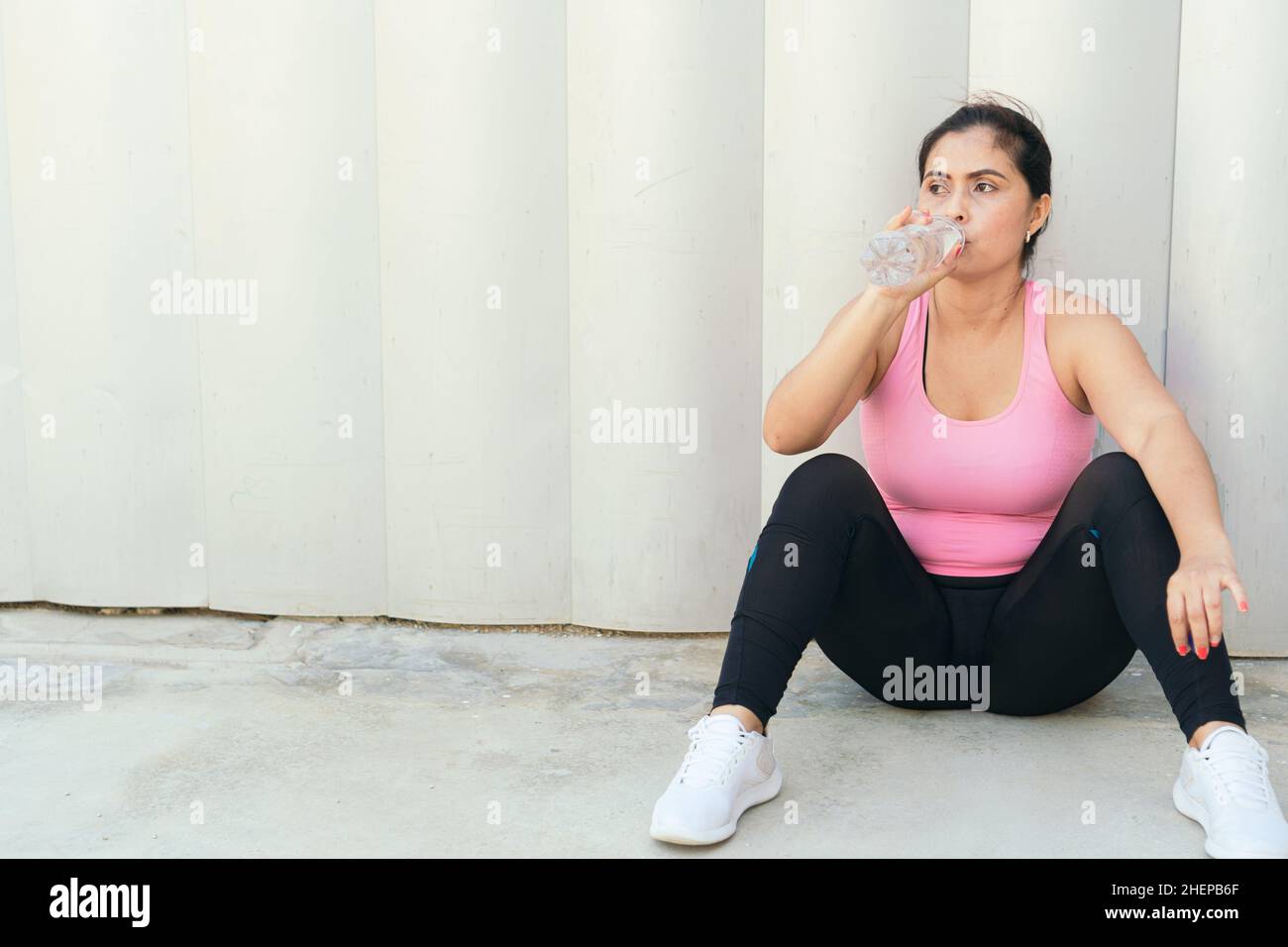 Athletic Woman Drinking Water During Workout Stock Photo - Alamy