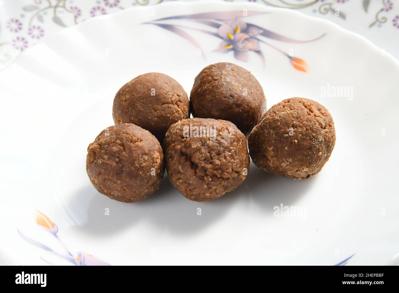 Coconut laddu. Traditional semi-fried Indian sweet made of coconut and ...
