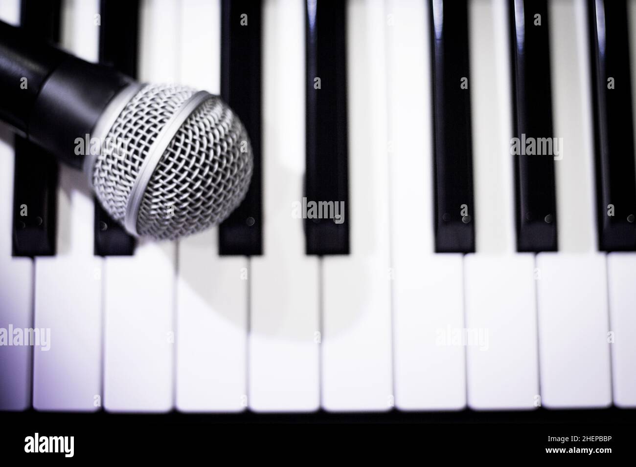 Microphone over piano keys in dim light. No people Stock Photo - Alamy