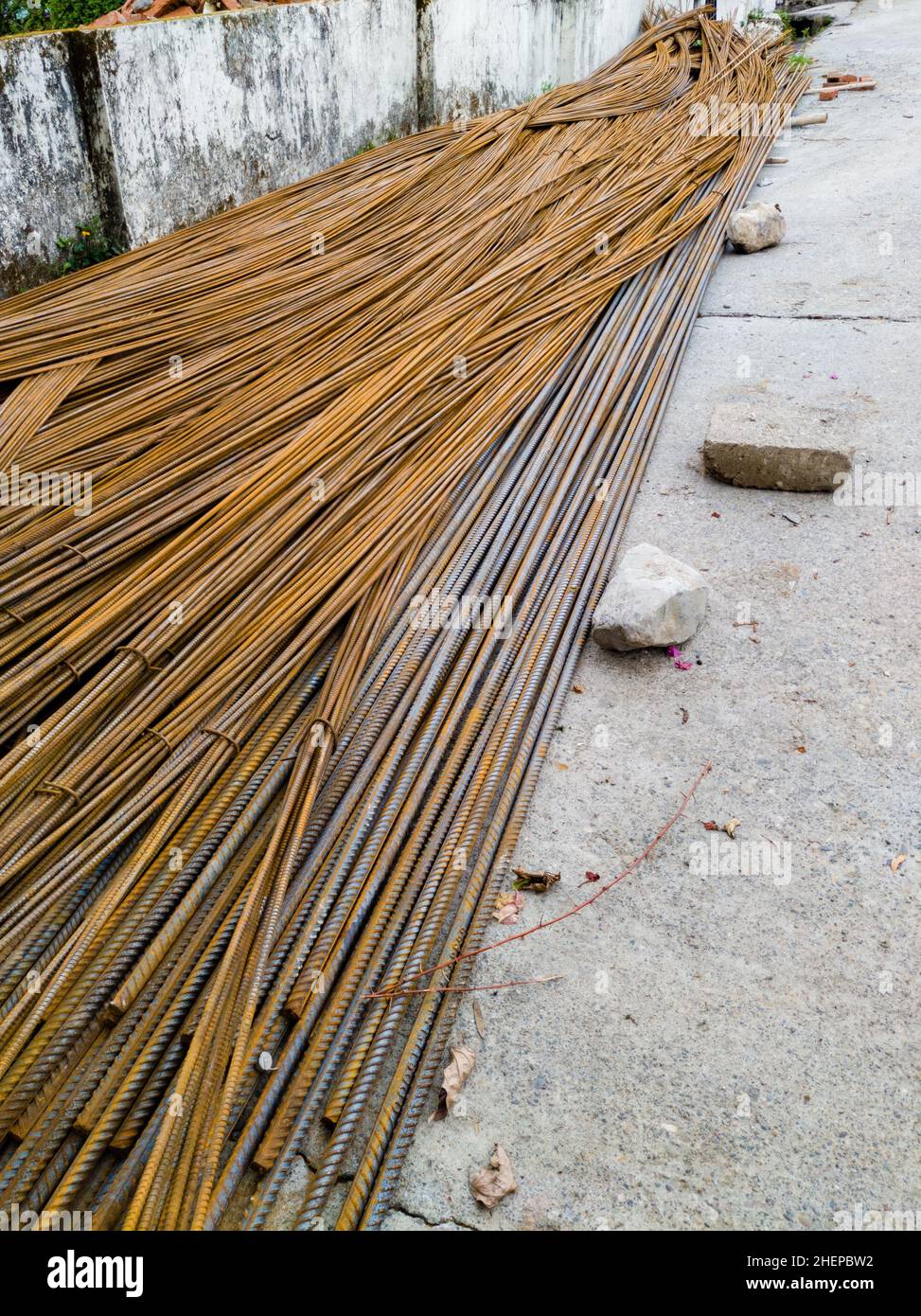 A pile of construction steel laying on the ground near a construction ...